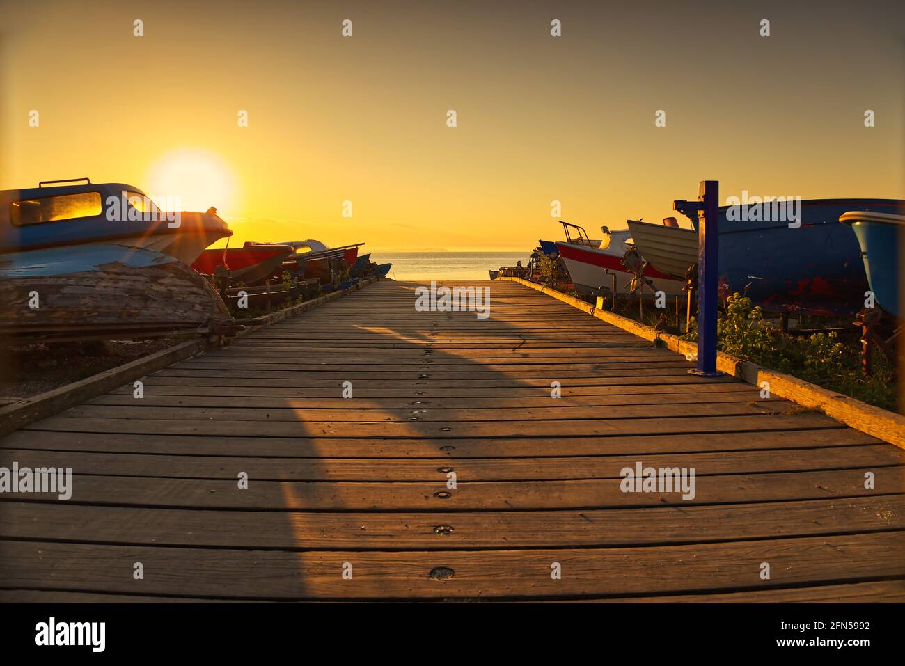 Boats on a slipway at Whitstable Yacht Club at sunset - Whitstable ...