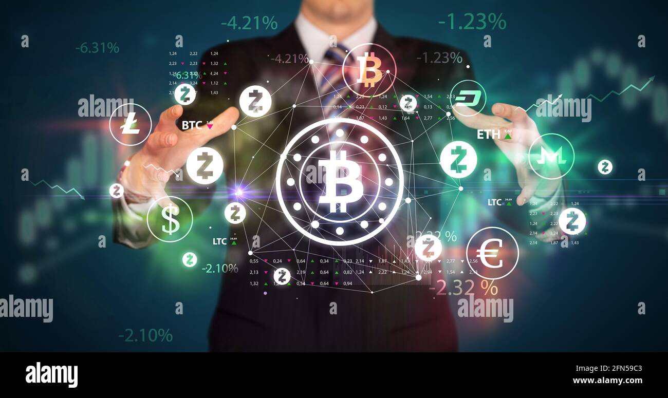 Businessman holding currency symbols concept Stock Photo - Alamy
