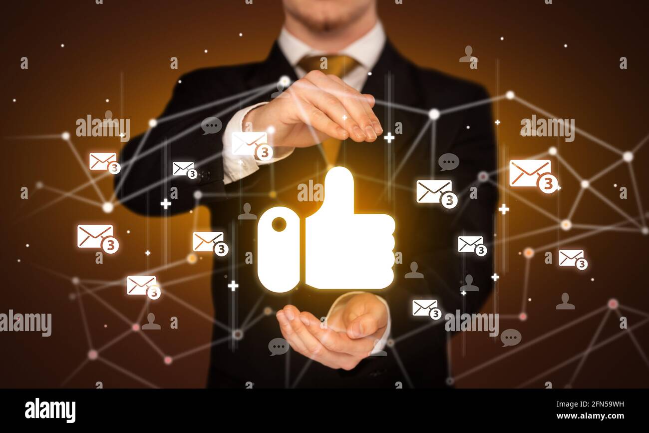 Hand holding social media icons Stock Photo - Alamy