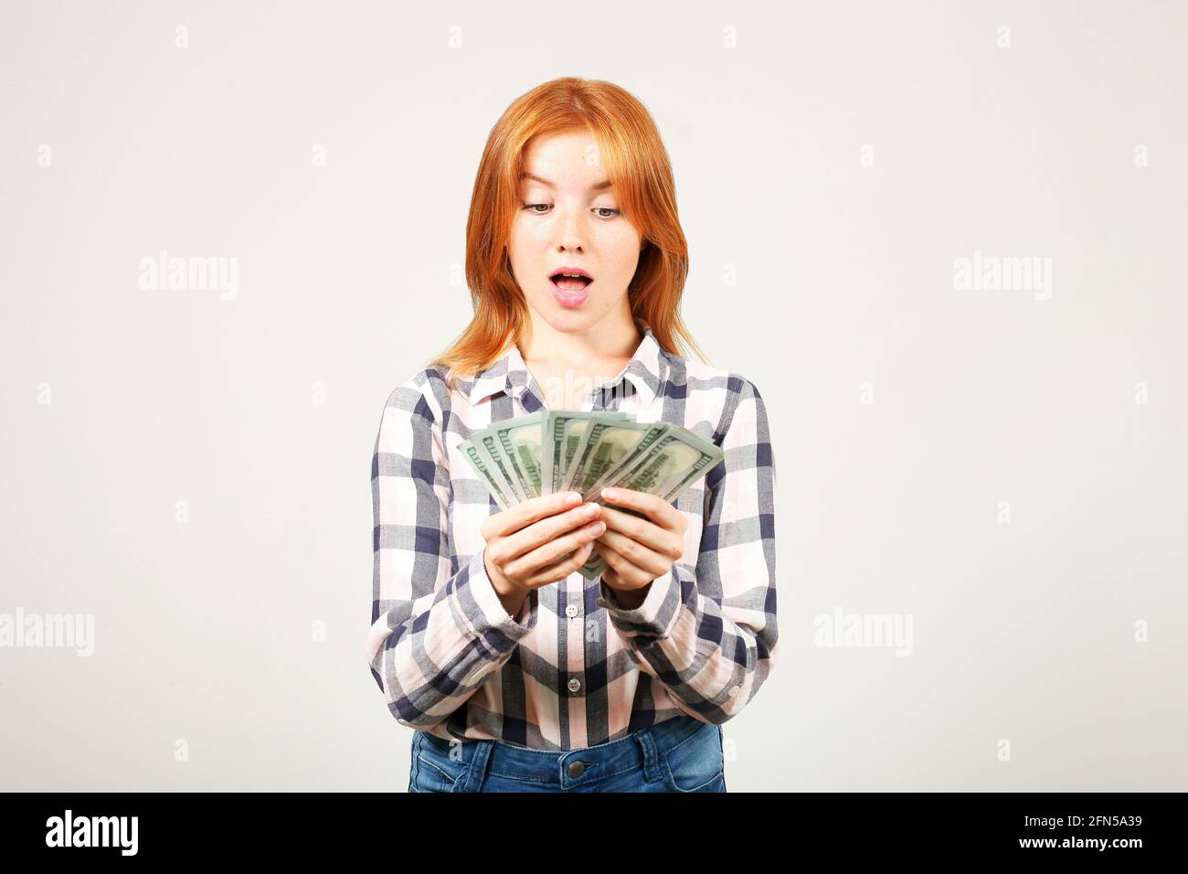 Young beautiful redhead woman screaming in rejoice, laughing w/ open ...