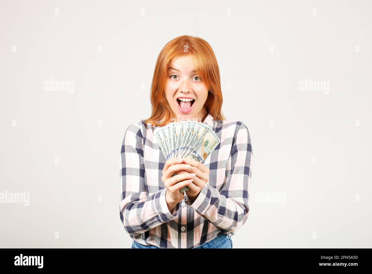 Young beautiful redhead woman screaming in rejoice, laughing w/ open ...