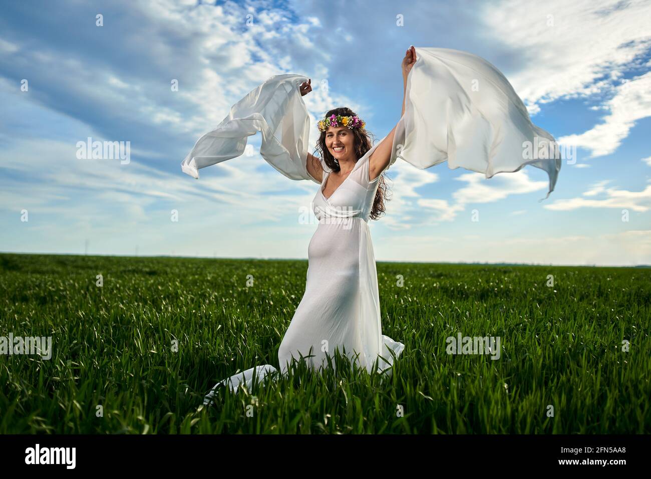 Young pregnant woman in a vaporous white dress in a wheat field Stock ...
