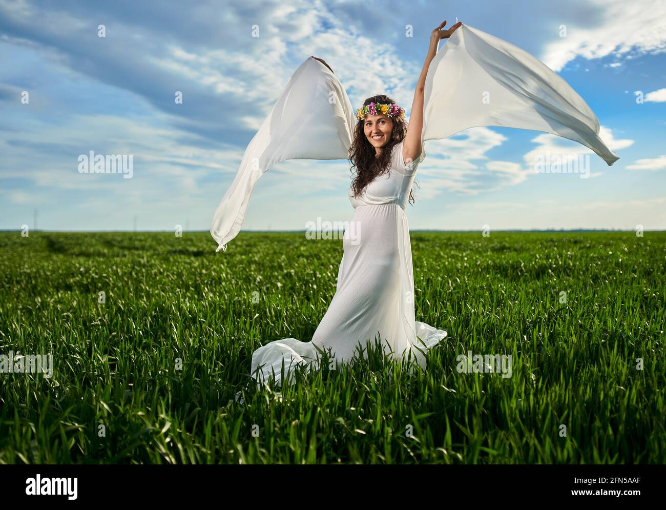 Young pregnant woman in a vaporous white dress in a wheat field Stock ...
