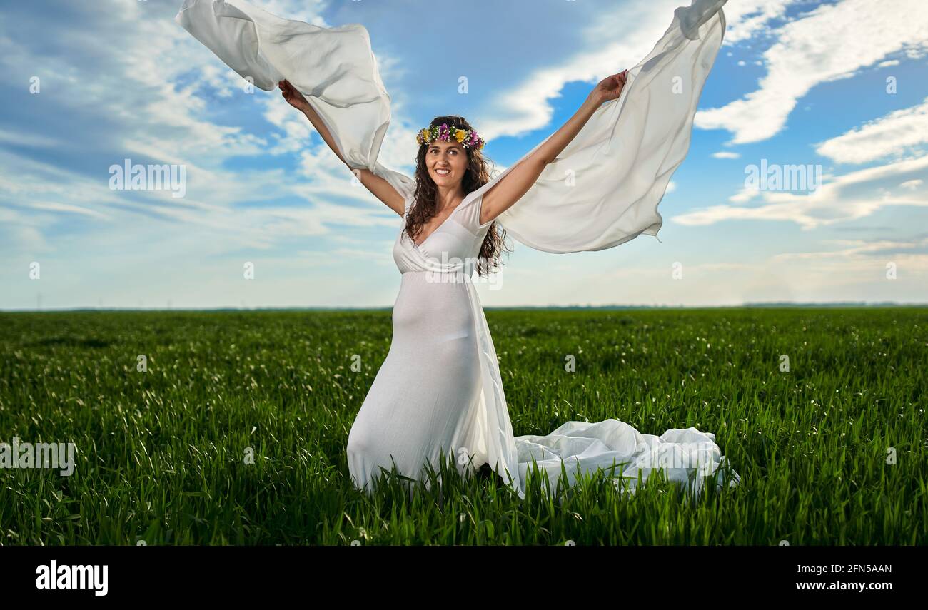 Young pregnant woman in a vaporous white dress in a wheat field Stock ...