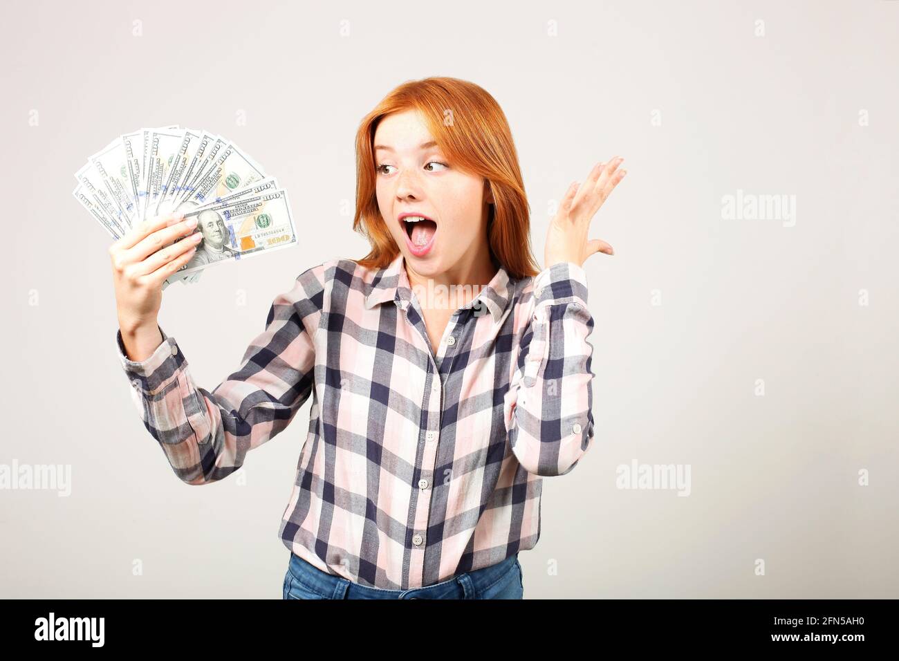 Young beautiful redhead woman screaming in rejoice, laughing w/ open ...