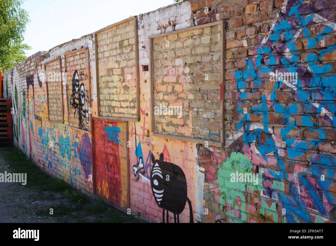 POZNAN, POLAND - Jun 04, 2015: Bricks wall with colorful graffiti in ...
