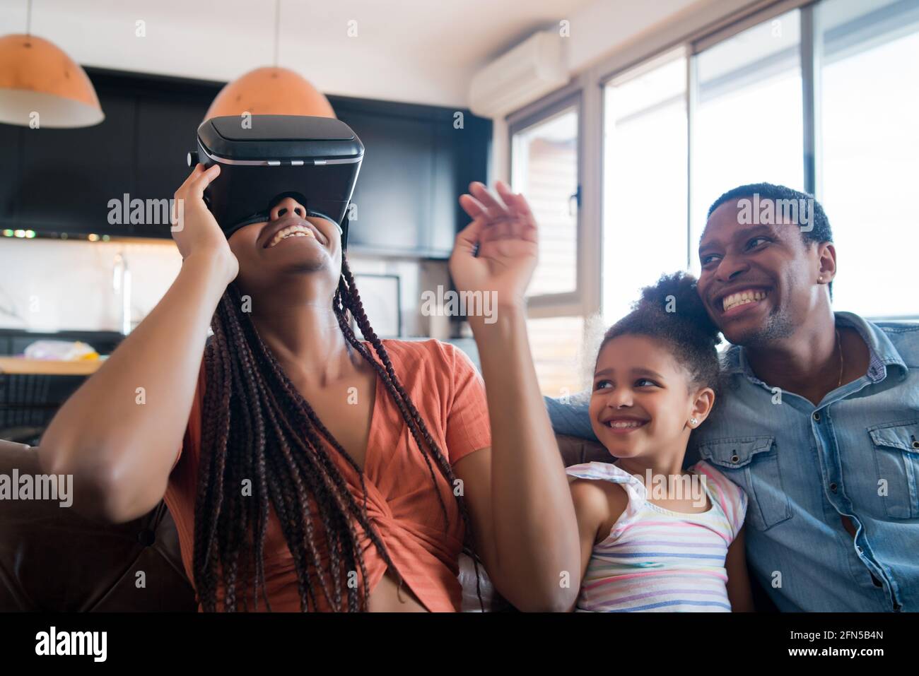 Family playing video games with VR glasses Stock Photo - Alamy