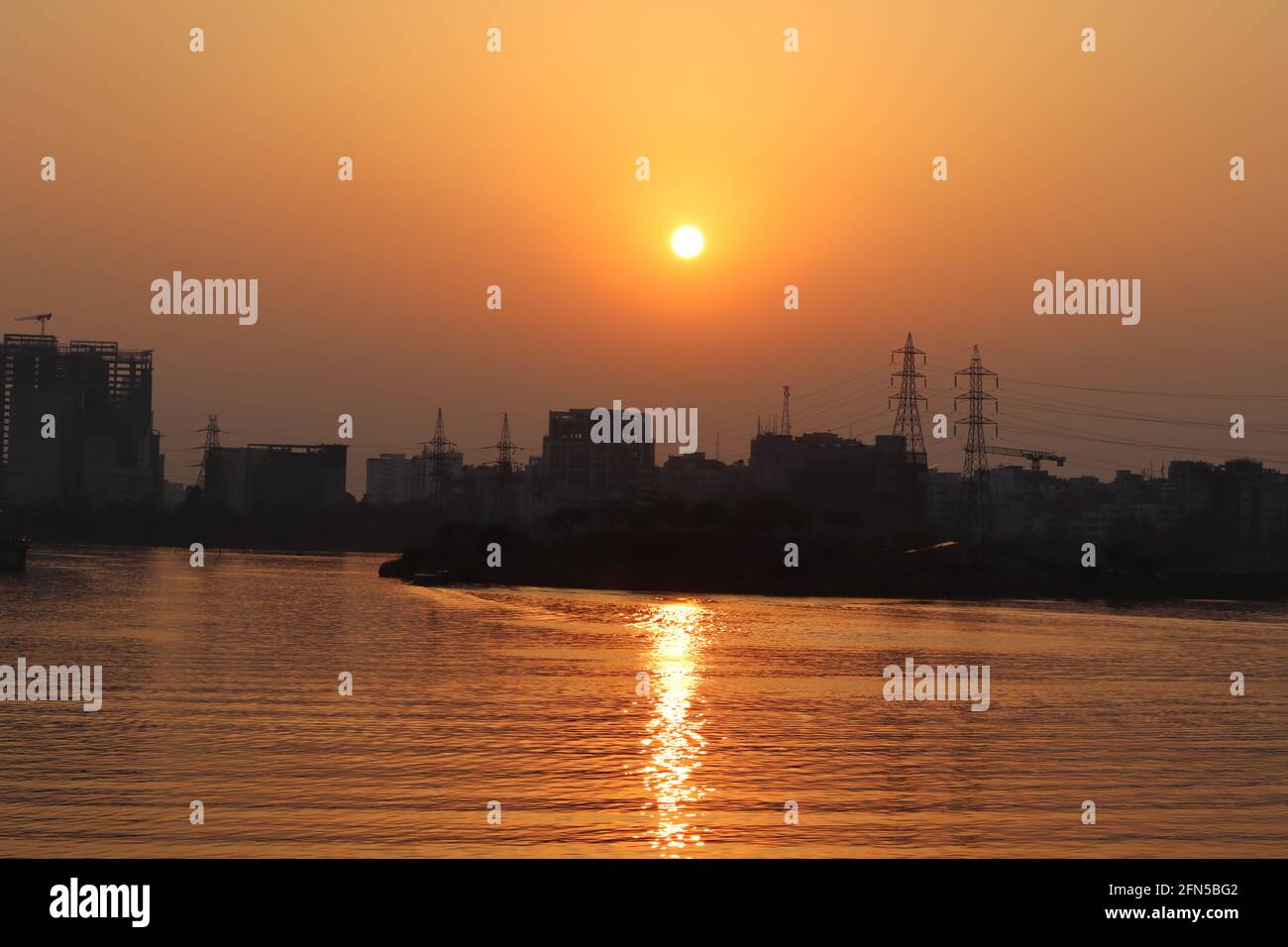 sunset with town Stock Photo - Alamy