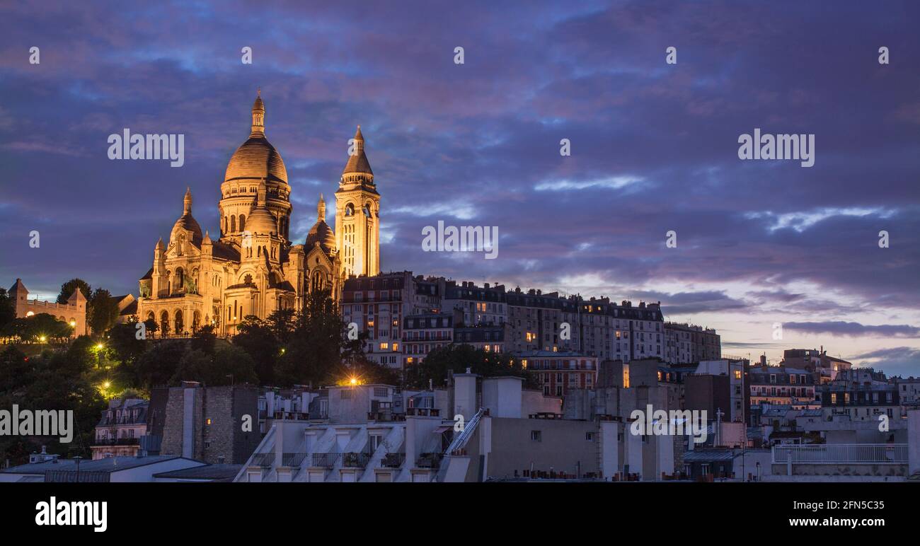 At sunset at summertime in front the Sacre-Coeur at the rooftop of a ...