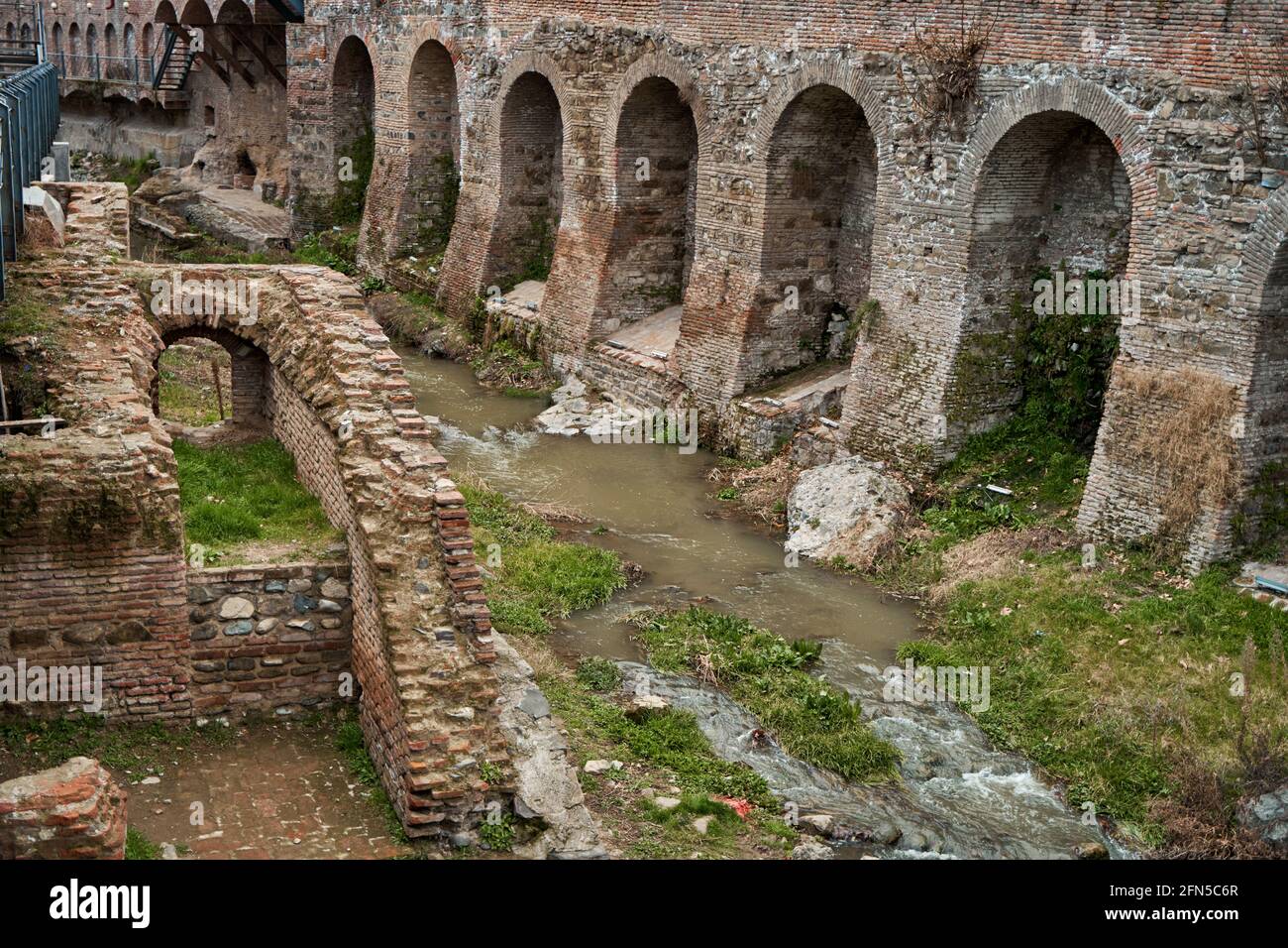 An old river channel with a small mountain river Stock Photo - Alamy