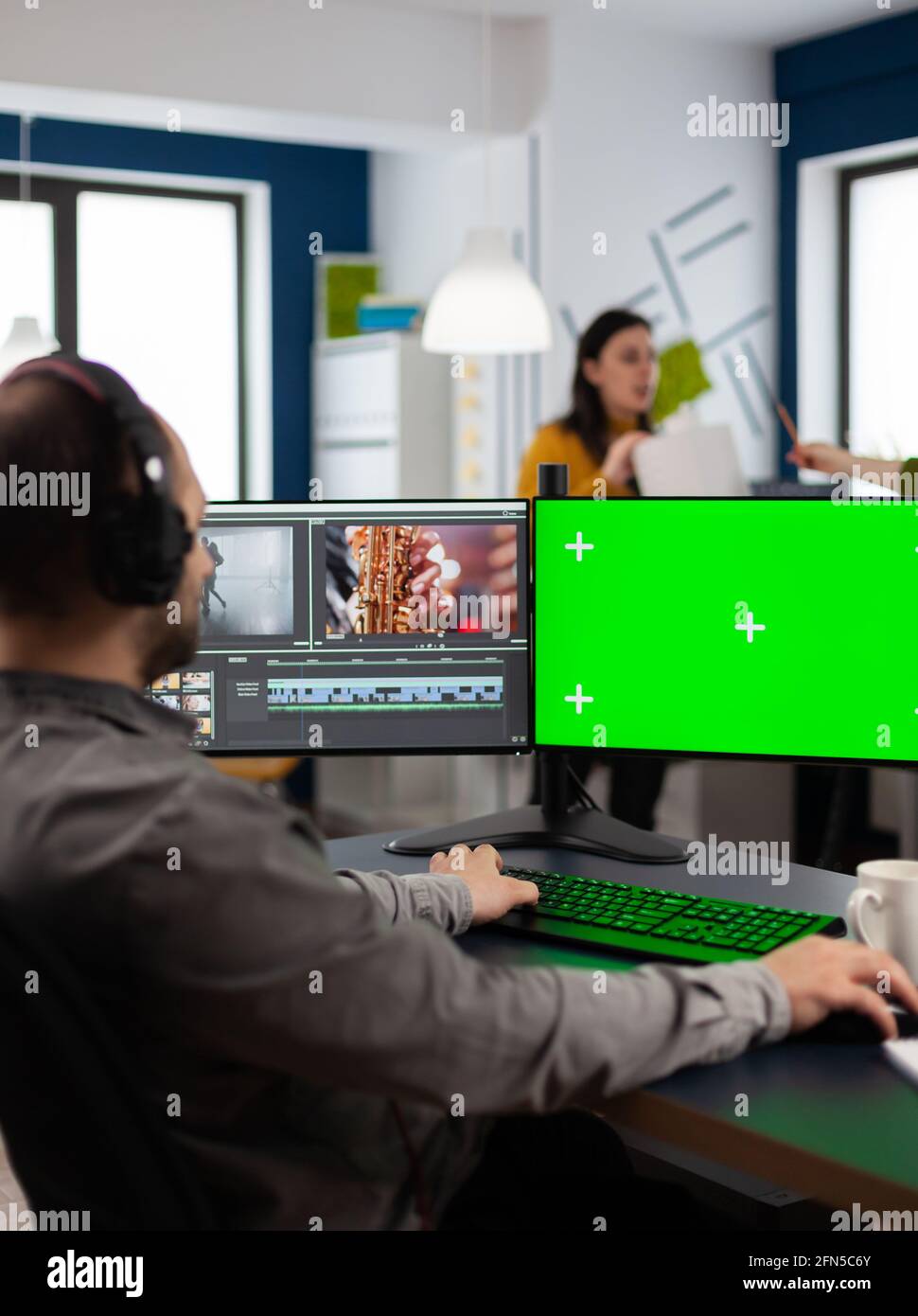 Video editor processing movie montage cutting footage at pc with green ...