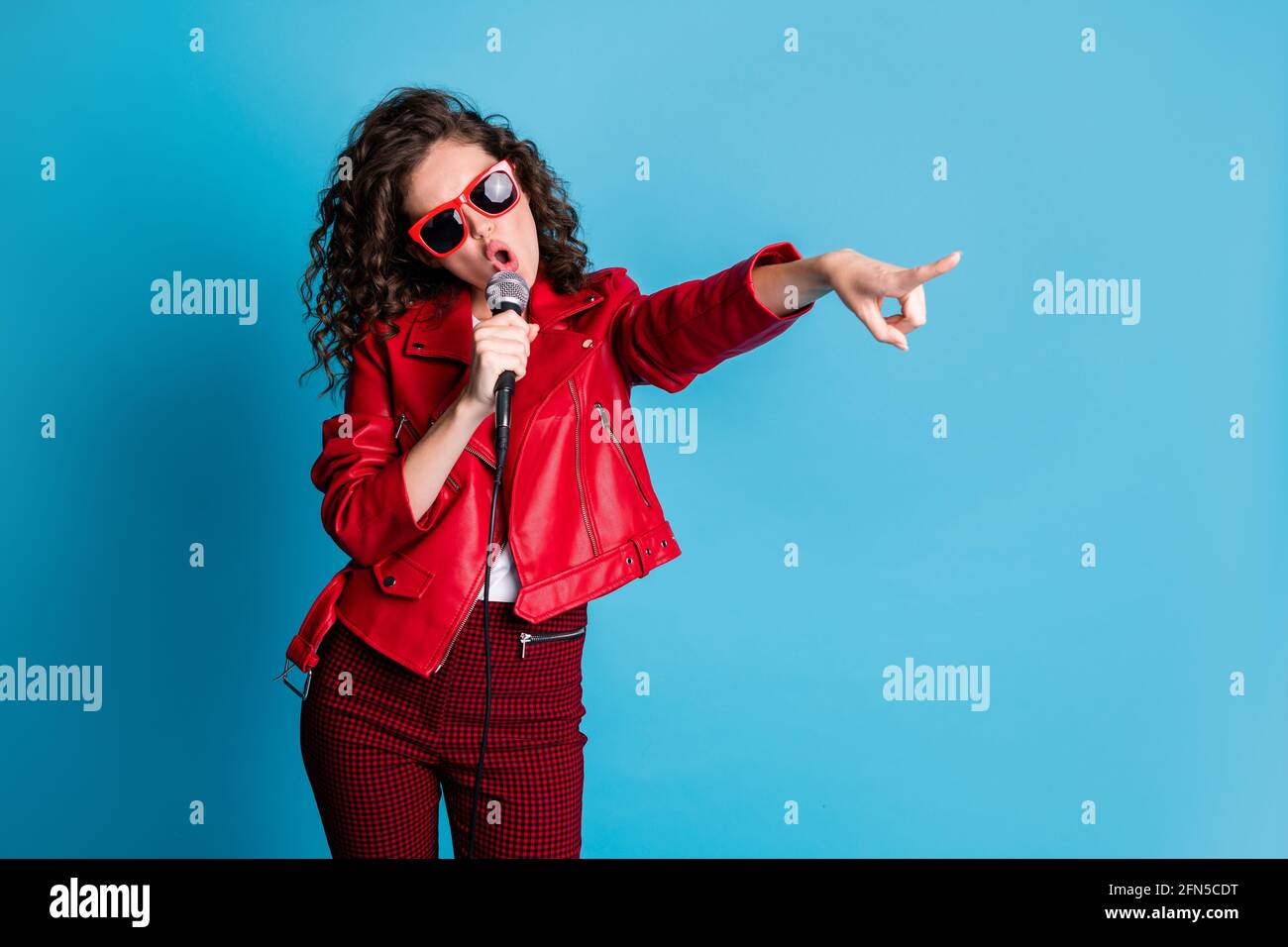 Portrait of attractive person open mouth singing hold mic idicate ...