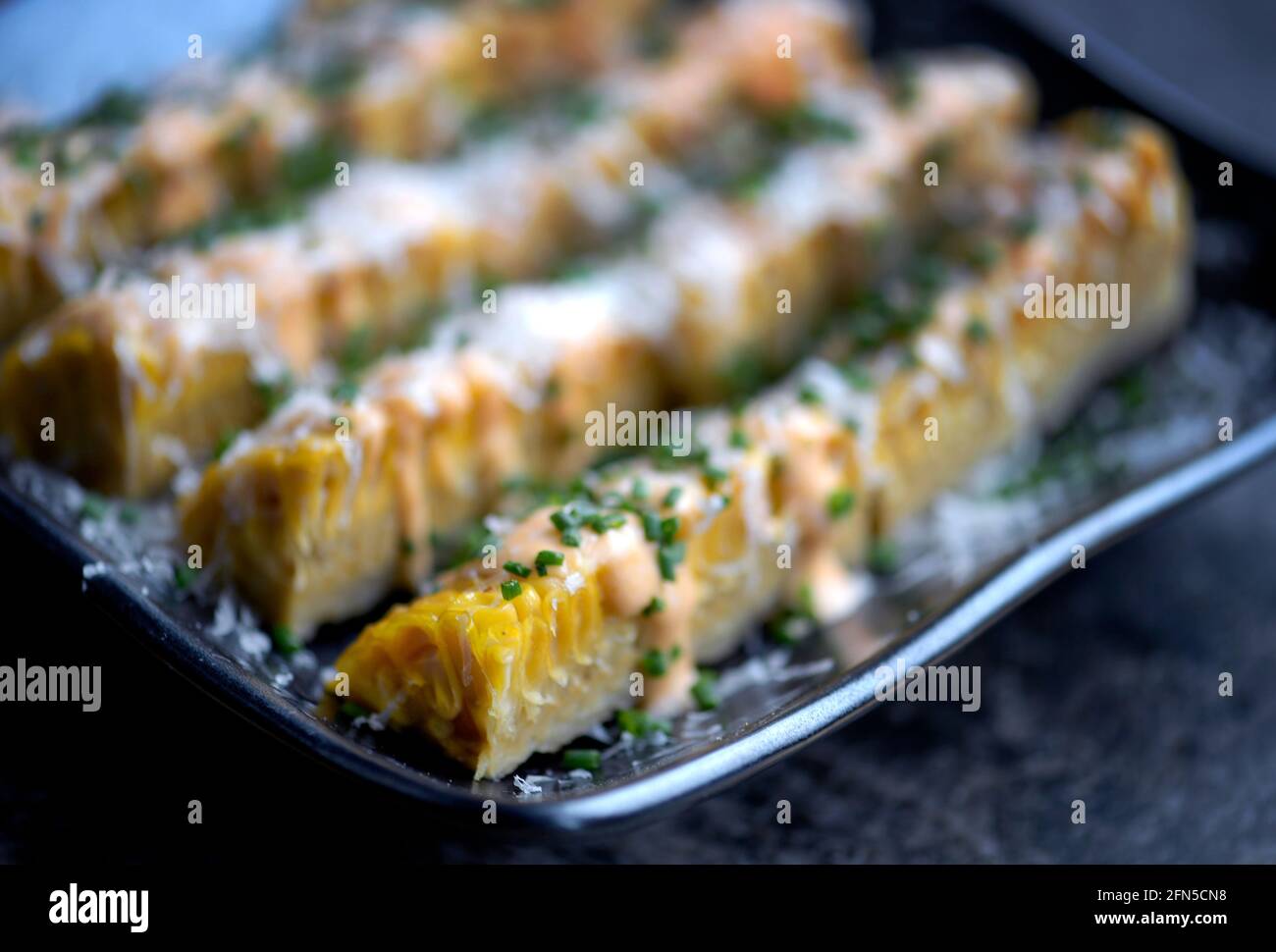 Butter-fried corn on the cob topped with srirachama mayonnaise chili ...