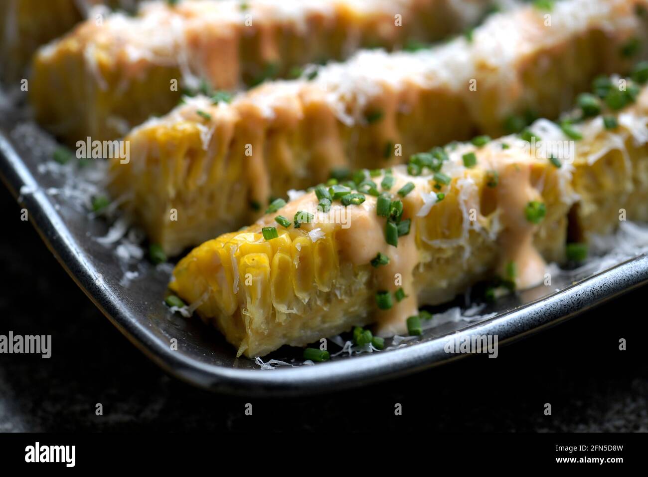 Butter-fried corn on the cob topped with srirachama mayonnaise chili ...