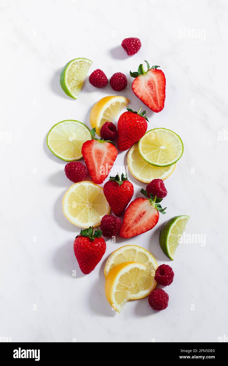Assortment of citrus slices, raspberry and strawberry for preparing a ...