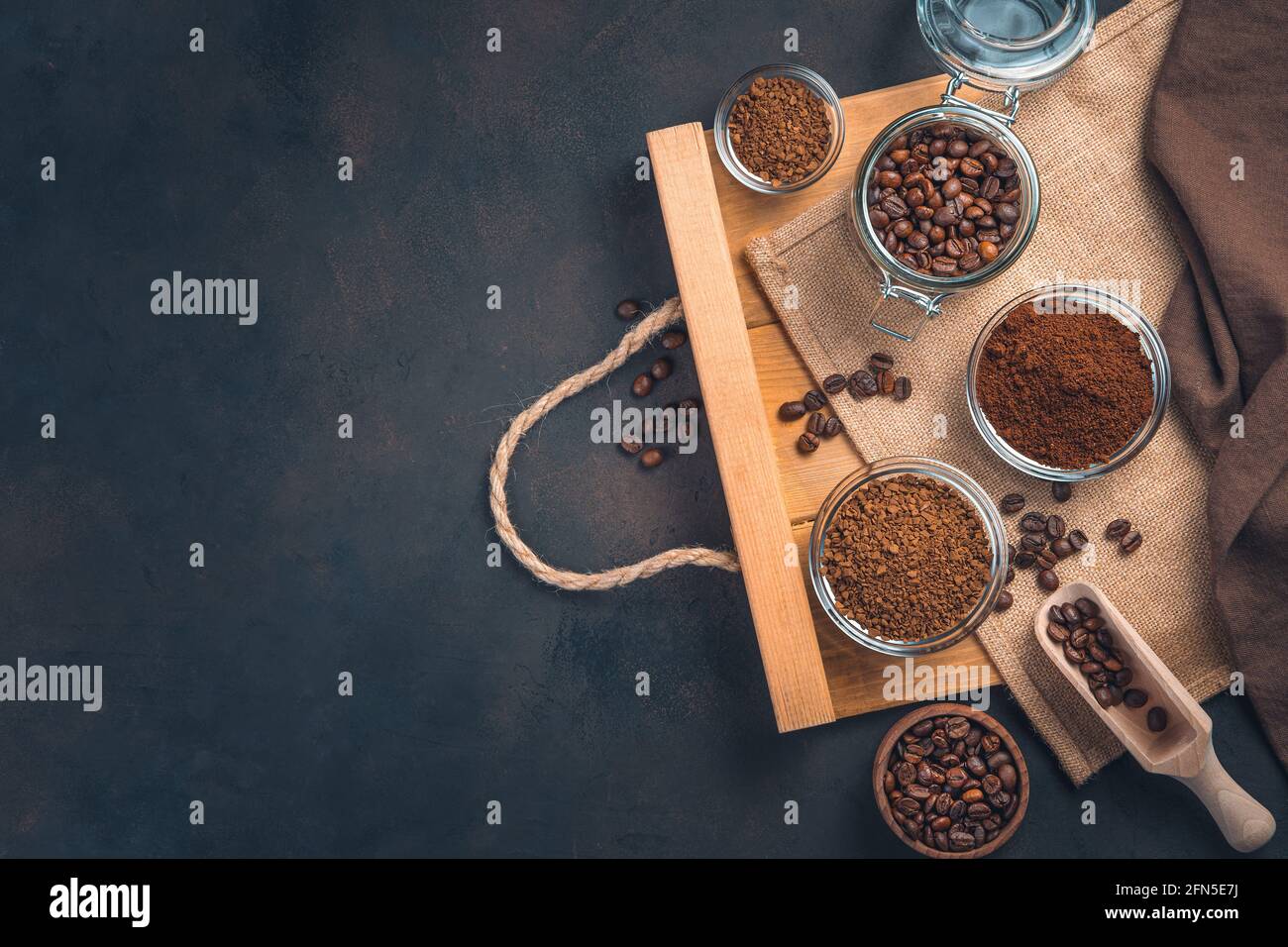 Different types of coffee: grain, granulated, ground on a brown ...