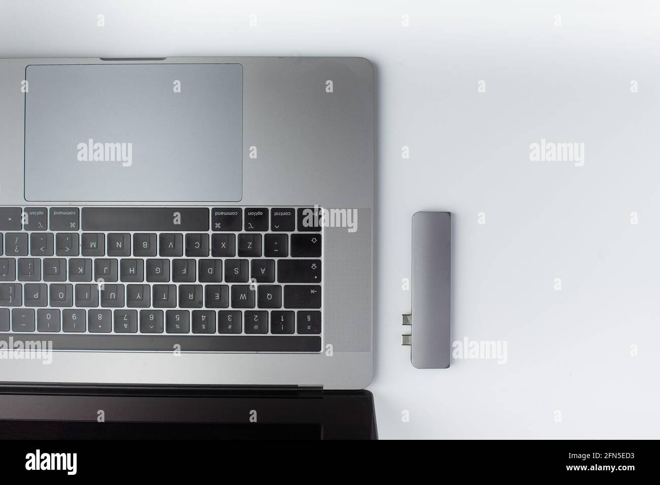 Close-up photo of a USB type-c hub that lies to the side of the laptop ...