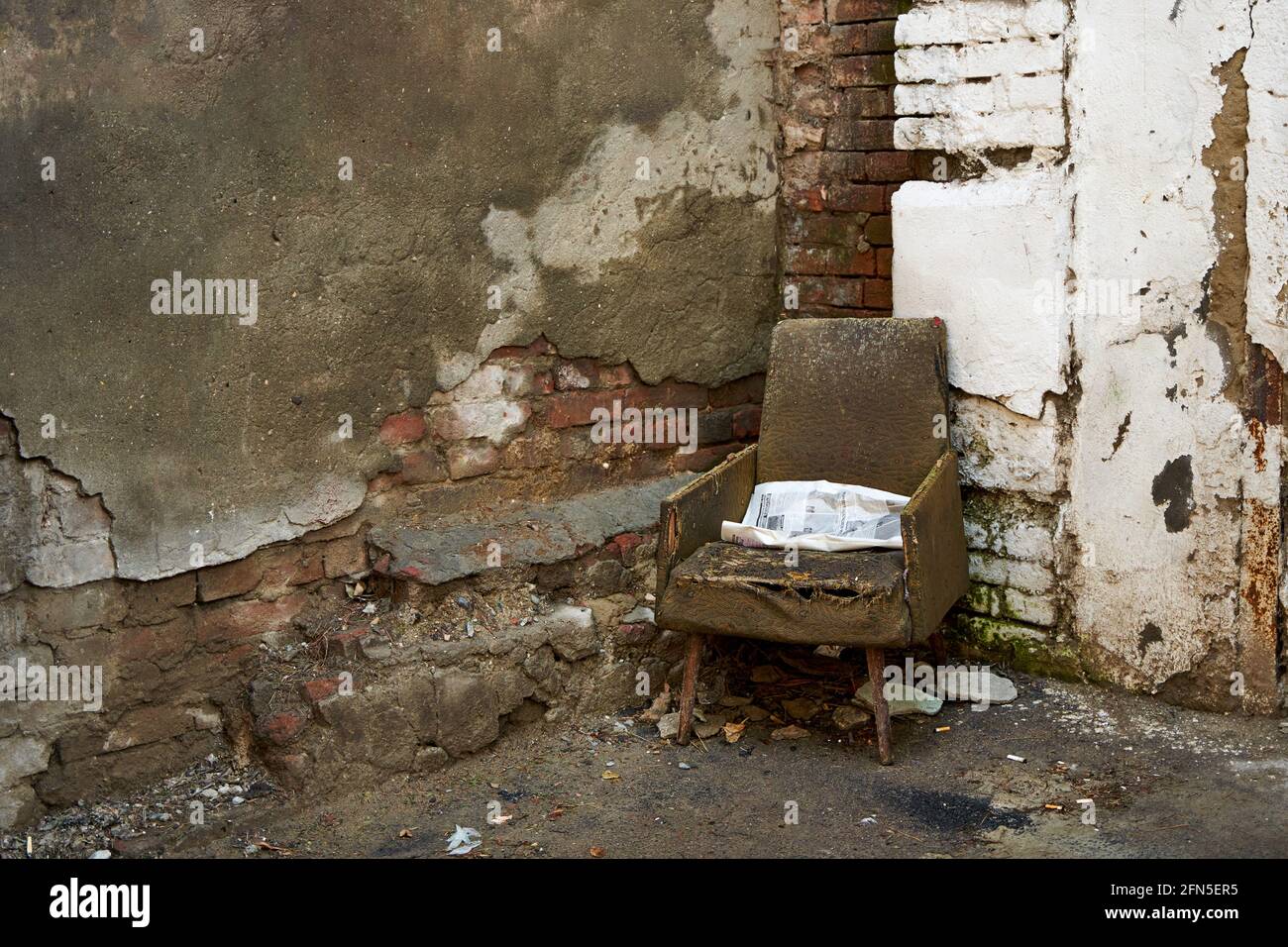 The atmosphere of devastation. An old decrepit chair with a snowy ...