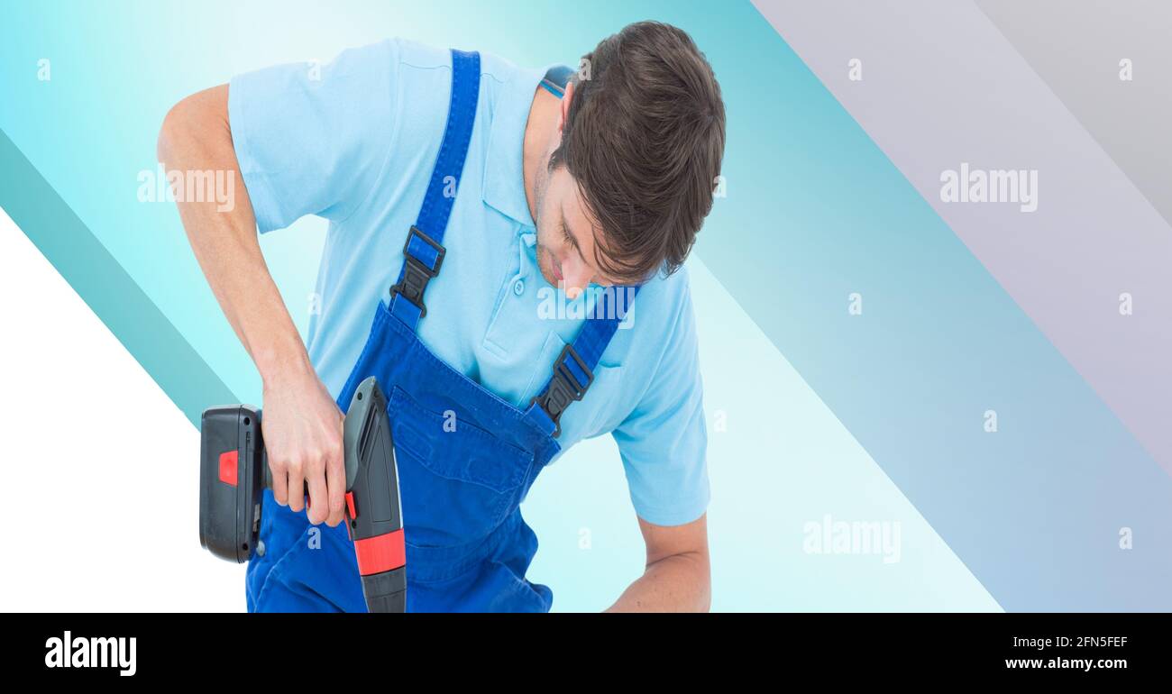 Caucasian handy man using drill on blue and white stripes Stock Photo ...