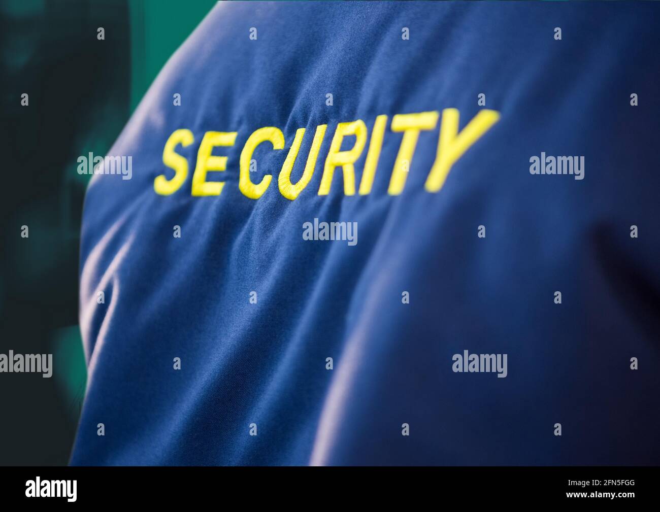 Composition of midsection of security guard blue jacket with yellow ...