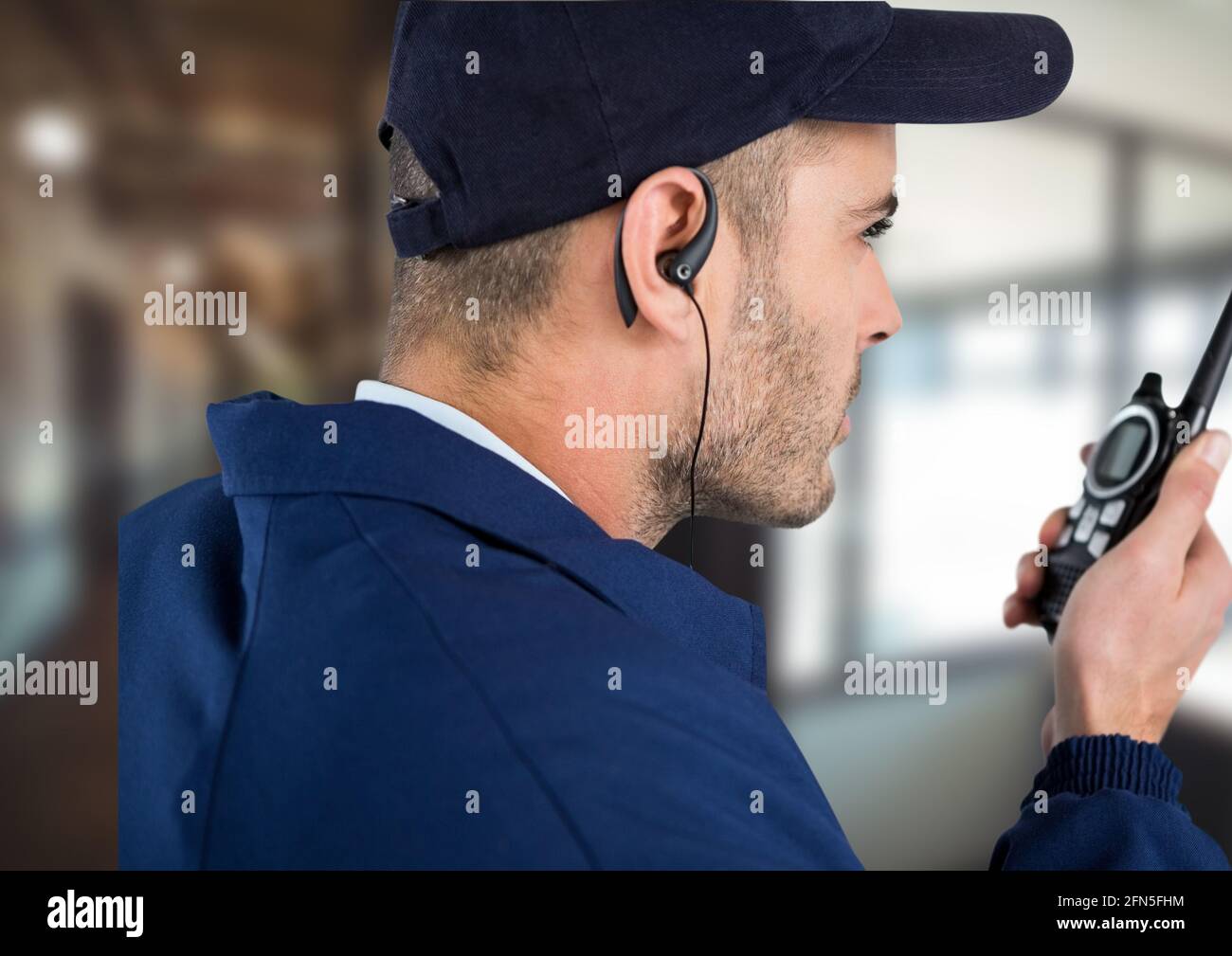 Composition of male security guard using walkie talkie and phone ...