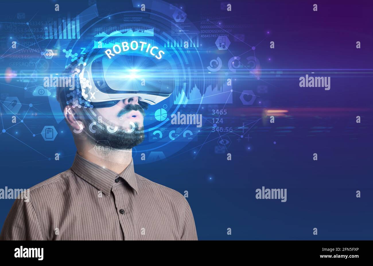 Businessman looking through VR glasses Stock Photo - Alamy