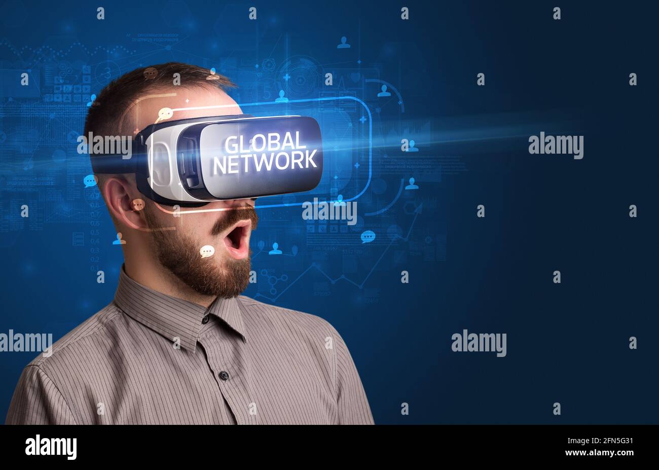 Businessman looking through Virtual Reality glasses, social media ...