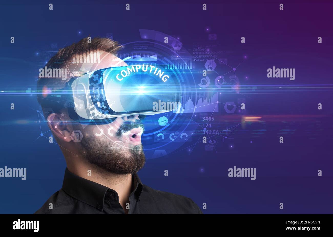 Businessman looking through VR glasses Stock Photo - Alamy