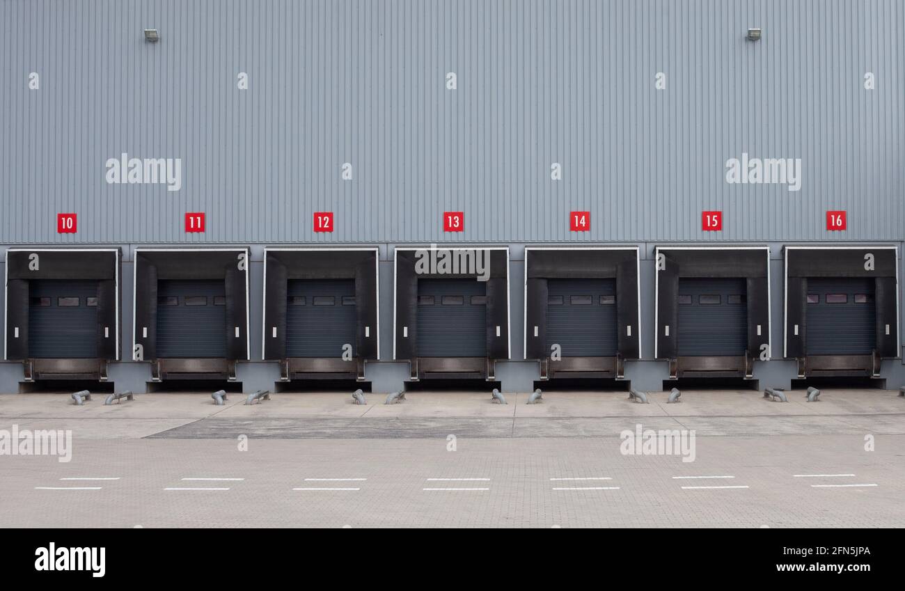 Storage entrances. Trucks at loading ramps of a warehouse Stock Photo ...