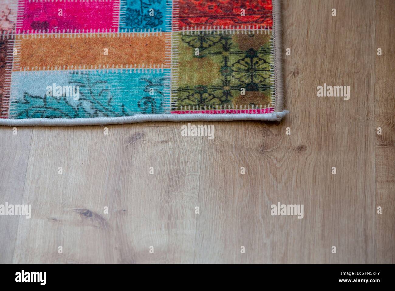 colorful carpet on parquet floor. Top view Stock Photo - Alamy