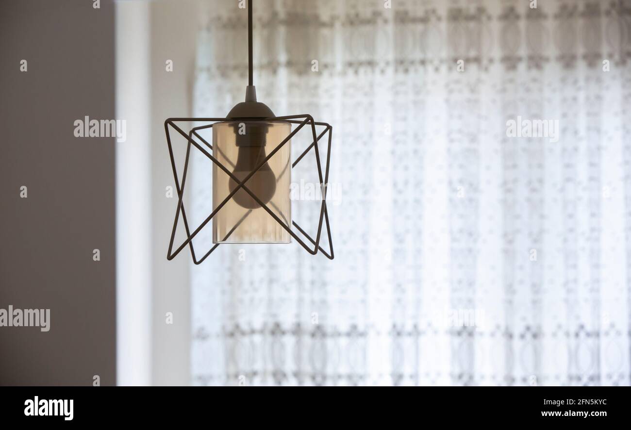 vintage chandelier on white wall. Front view Stock Photo - Alamy