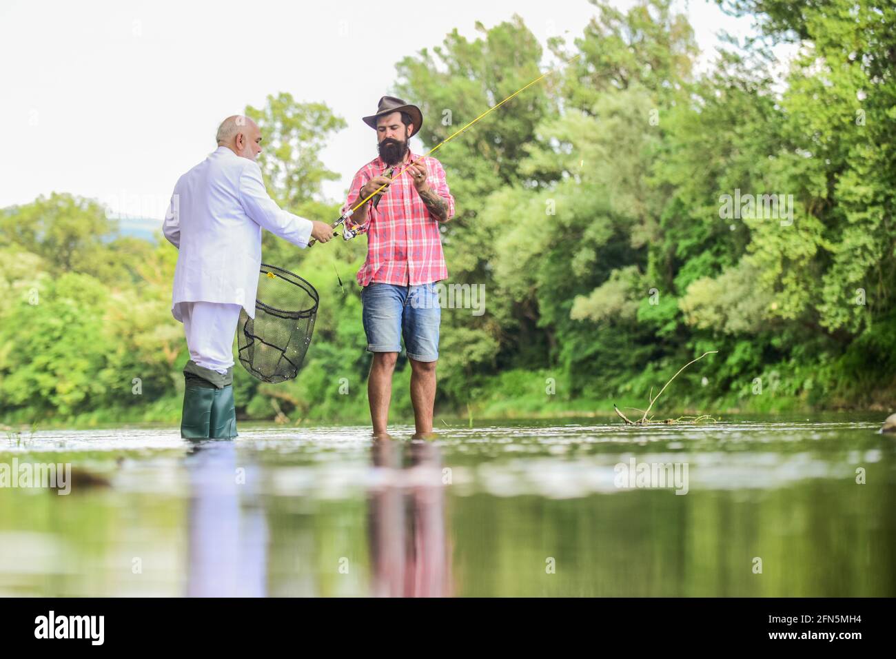 Fishing skills. Fish with companion who help in emergency. Bearded man ...