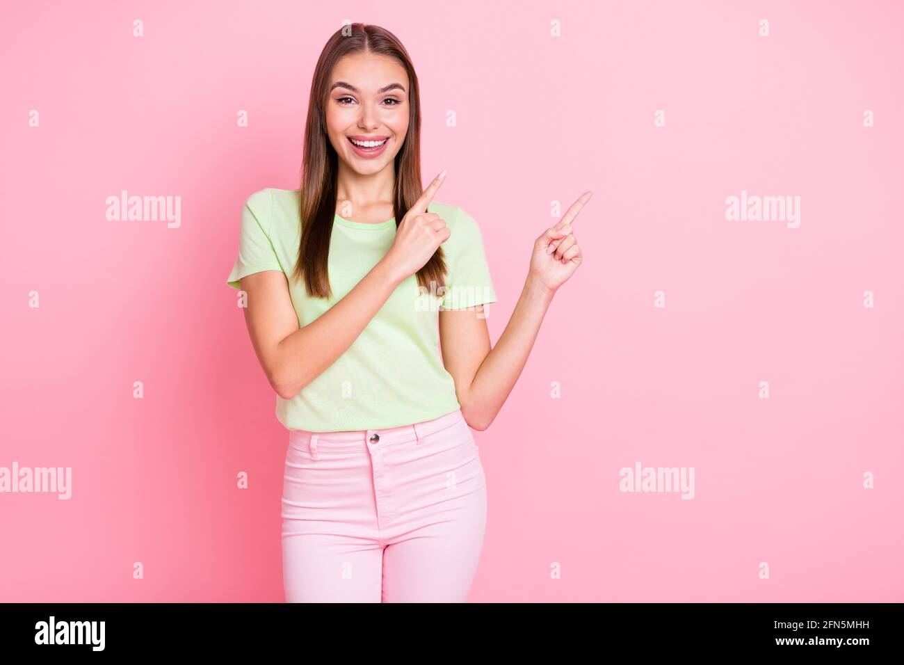 Photo of sweet adorable young lady wear green t-shirt smiling pointing ...
