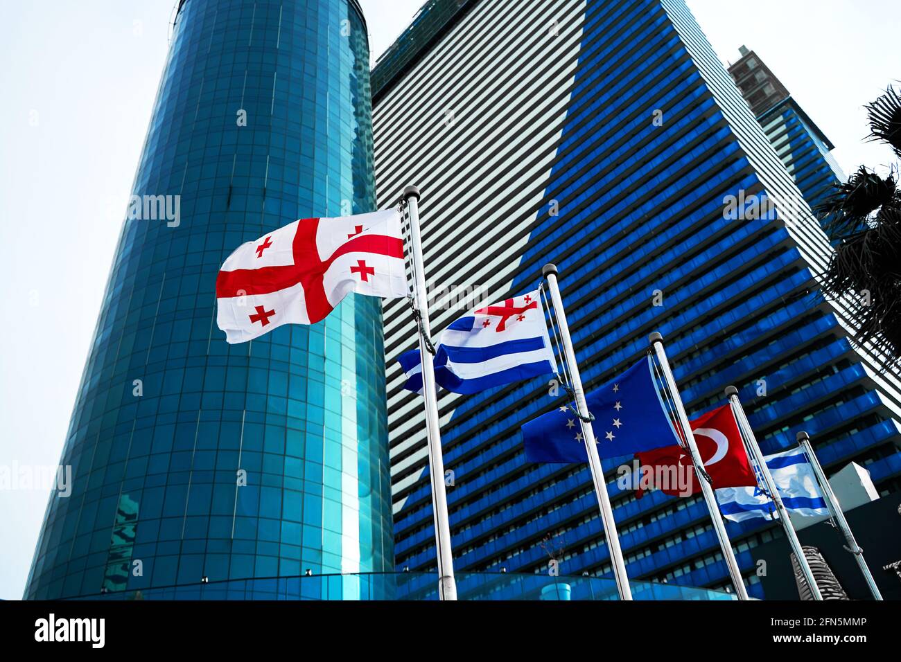 Flags of countries on flagpoles against the backdrop of modern ...