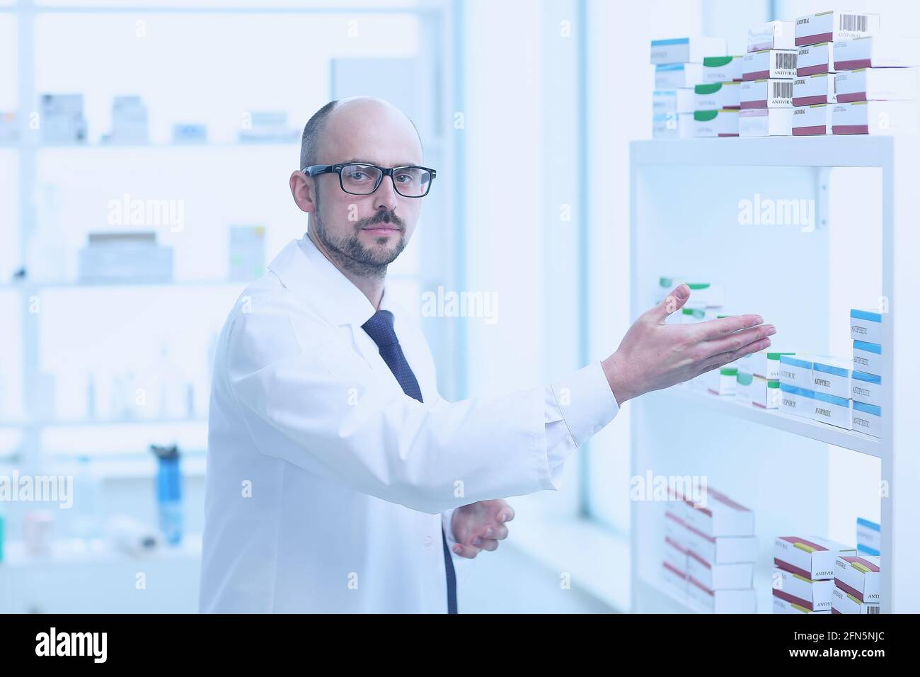 Pharmacist is working. Man wearing special uniform located in pharmacy ...