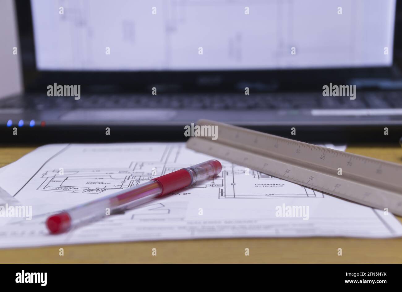 Selective focus shot of blueprints on paper and on a laptop screen on ...