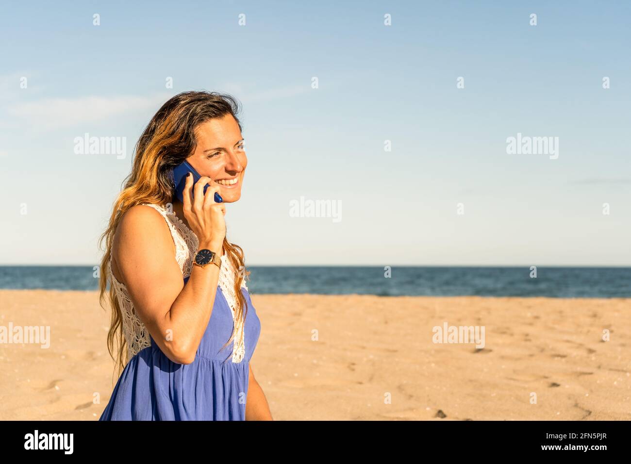 Woman beach talking on a cell phone hi-res stock photography and images ...