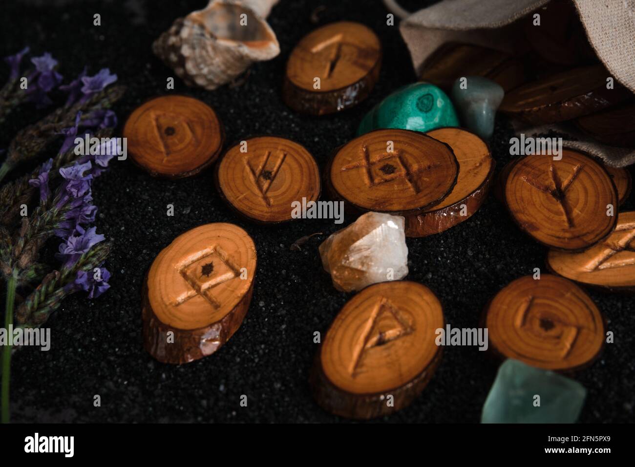 homemade wooden runes on a dark background Stock Photo - Alamy