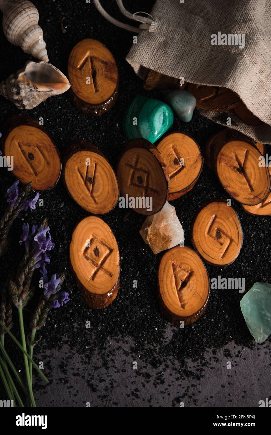 homemade wooden runes on a dark background Stock Photo - Alamy