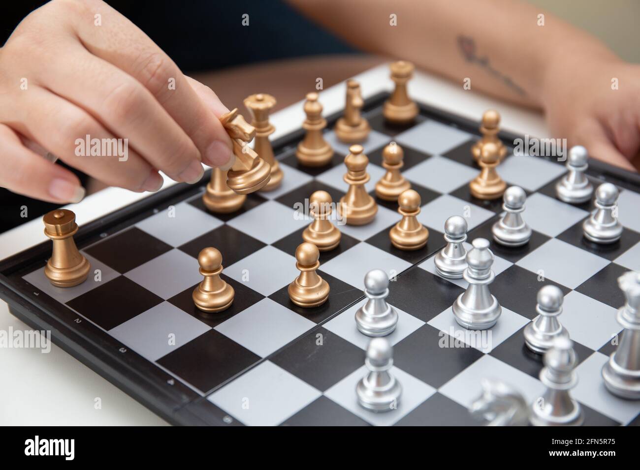 Woman moving chess piece hi-res stock photography and images - Alamy