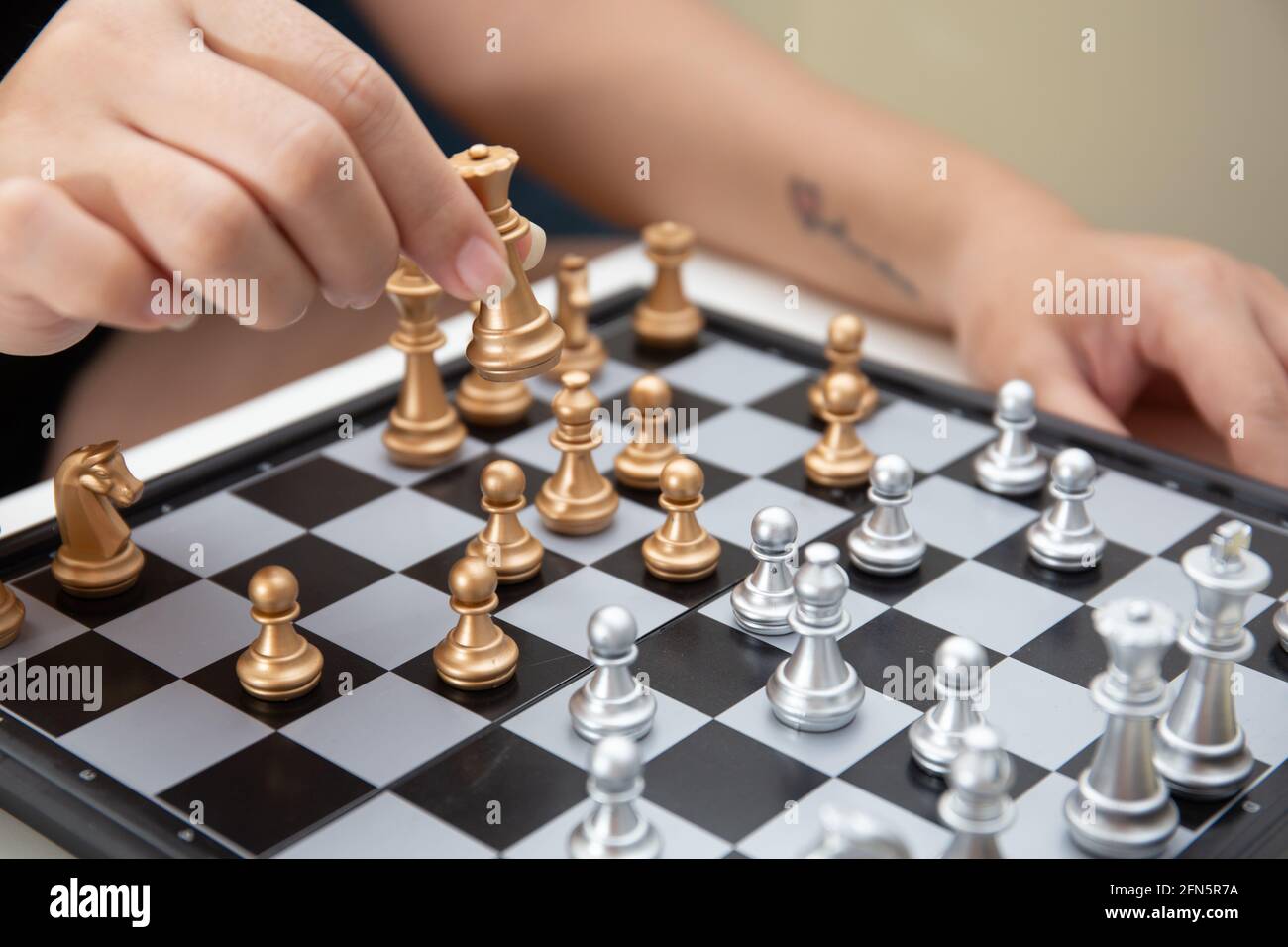 Female hand moving chess piece on the chessboard Stock Photo - Alamy