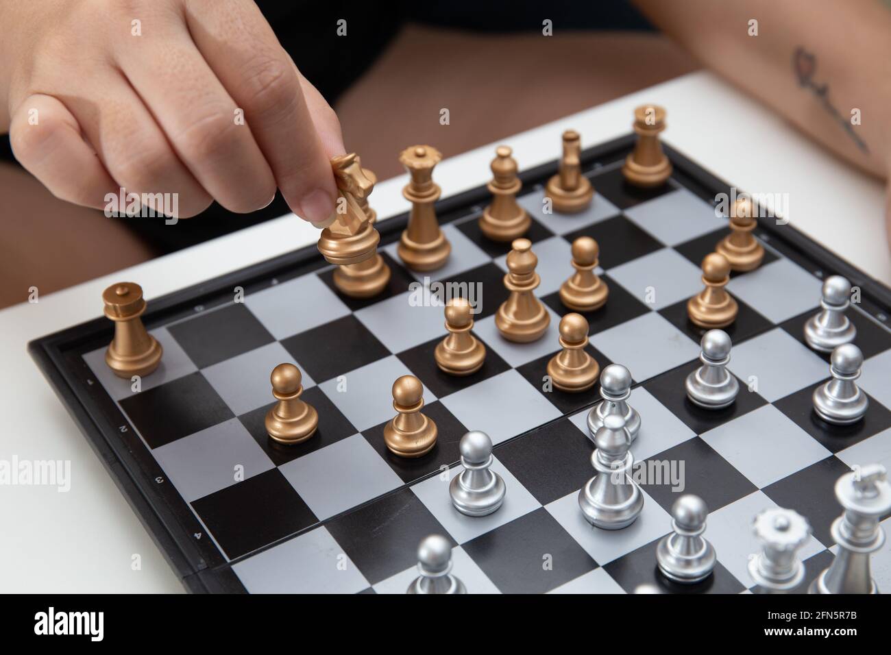 Female hand moving chess piece on the chessboard Stock Photo - Alamy