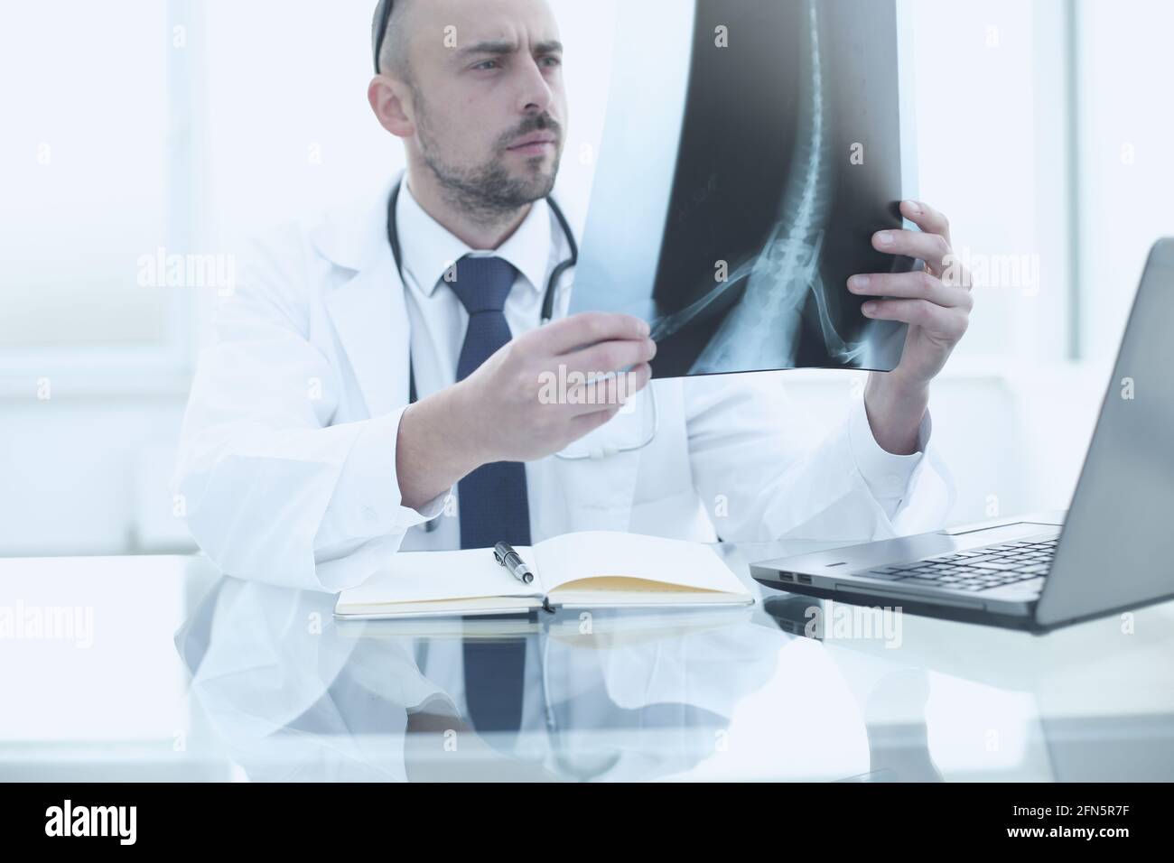 The doctor examines a snapshot of the patient's spine. The concept of ...
