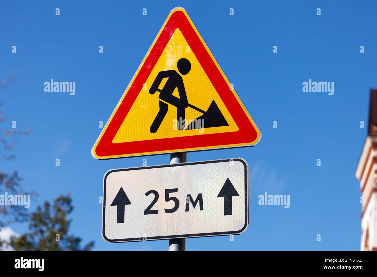 traffic sign. red triangle with a human figure with a shovel on a ...