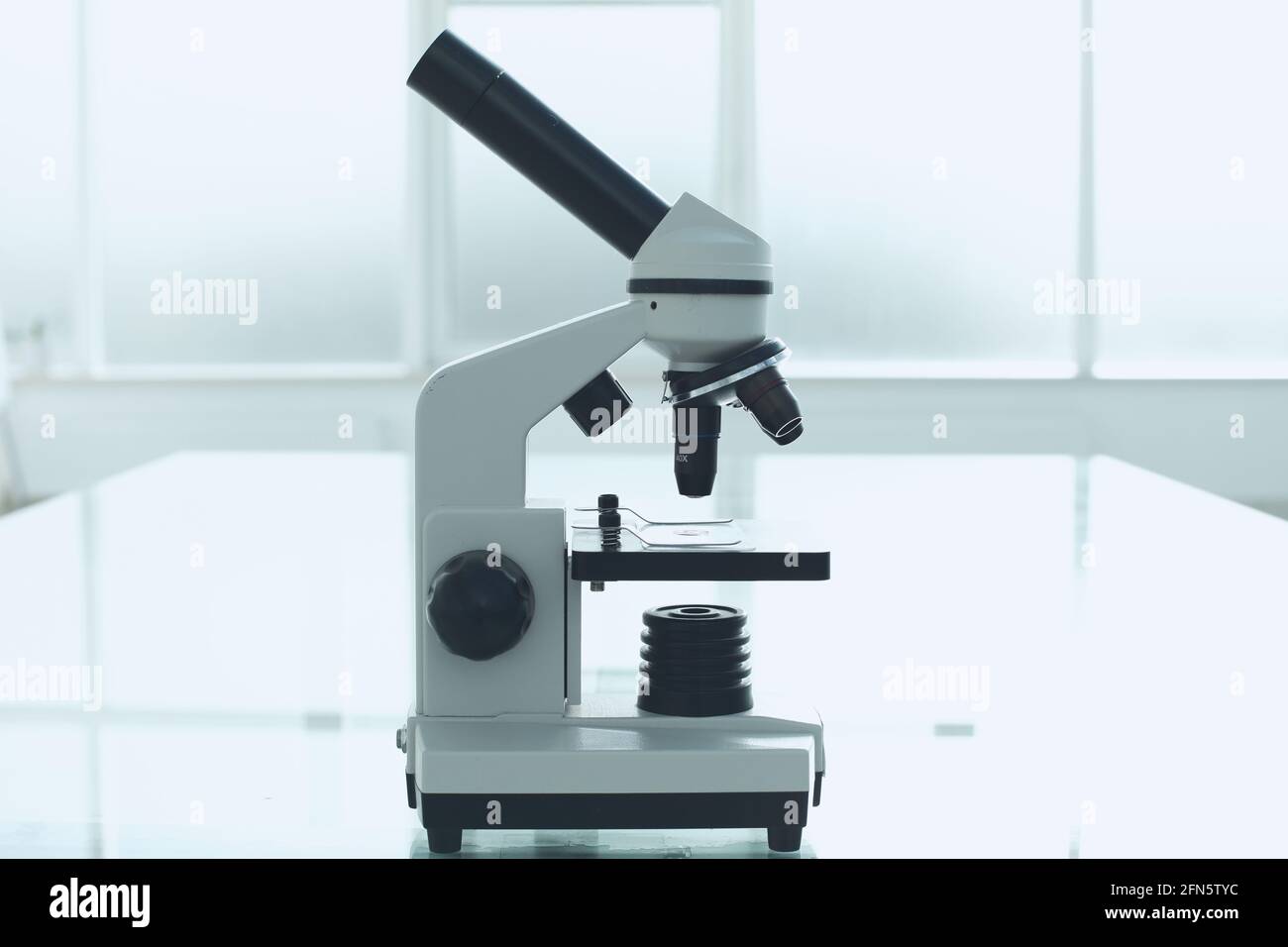 Microscope on a glass table in a bright room. Laboratory medical ...
