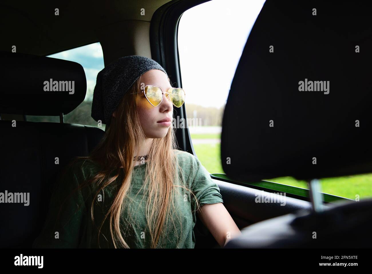 Beautiful tween girl with long blond hair and sunglasses in car Stock ...