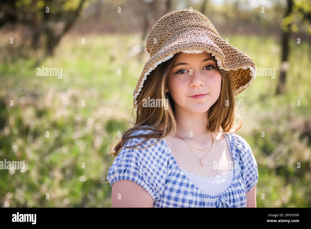 Beautiful Teen Girl Outdoors in blue checked sundress, backlit Stock ...