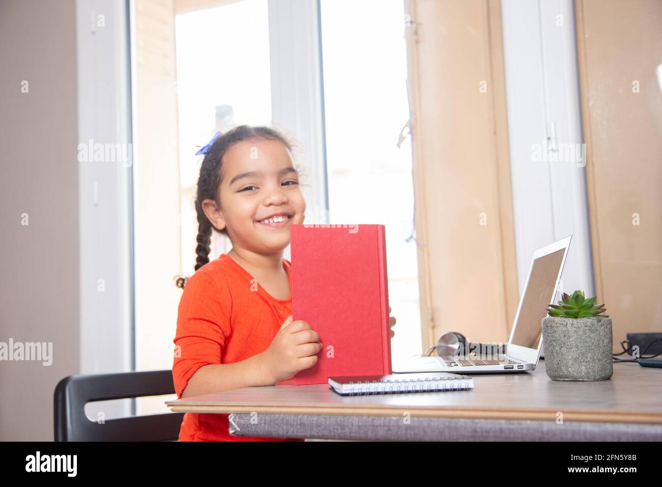 baby studying at home with his laptop and headphones . distance ...