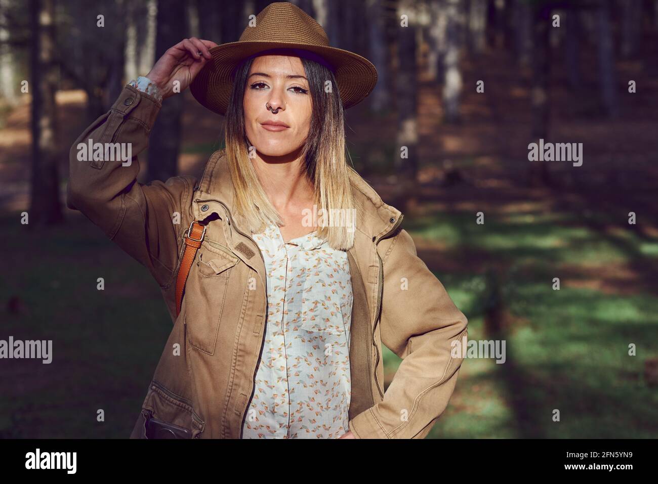 Woman on the mountain. She is in a forest with pine trees Stock Photo ...
