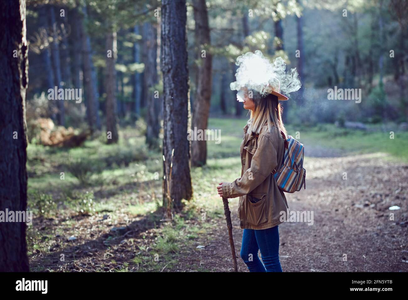 Woman on the mountain. She is in a forest with pine trees Stock Photo ...